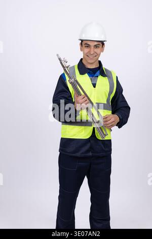 Hands holding construction tools on beige background Stock Photo - Alamy