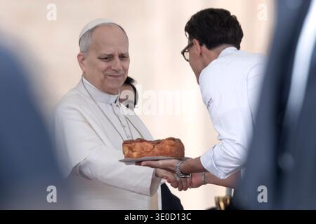 Pope Leo XIV receives a cake during his weekly general audience in St ...