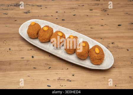 Chicken and curry croquettes, with a yellowish color and a spicy aroma ...
