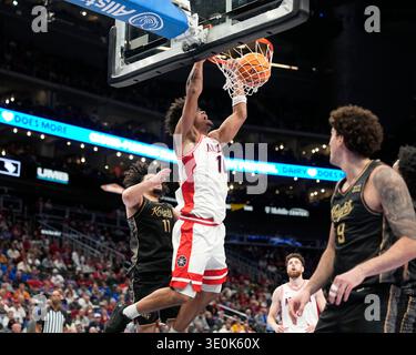 Arizona forward Koa Peat, center, shoots past Purdue center Oscar Cluff ...