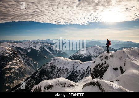 A climber stands on the summit of Needle Peak Stock Photo - Alamy