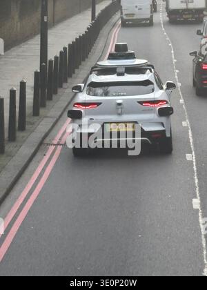 Autonomous Waymo Jaguar I-PACE self-driving car crossing light rail ...