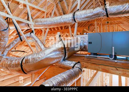 Workers are building wooden frame with ductwork in new construction ...