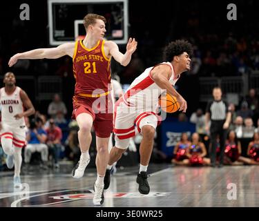 Arizona forward Koa Peat, center, shoots past Purdue center Oscar Cluff ...