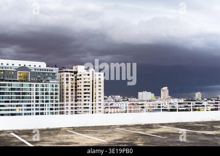 Heavy dark storm clouds covering the sky with patches of blue light ...