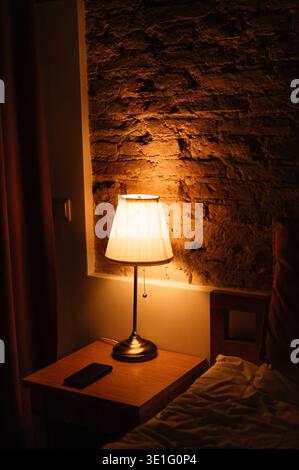 Interior of bedroom with modern furniture and glowing lamps at night ...