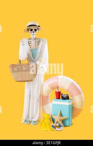 Human skeleton and beach accessories on yellow background with space ...