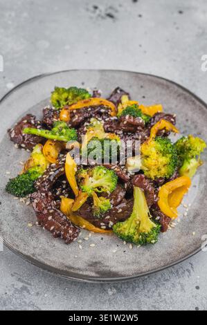 Chinese Beef and Broccoli Skillet served on a dark textured background ...