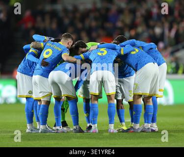 Brentford players huddle before the Premier League match between ...