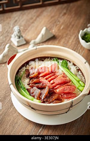Traditional Cantonese claypot rice with cured pork belly bacon on ...