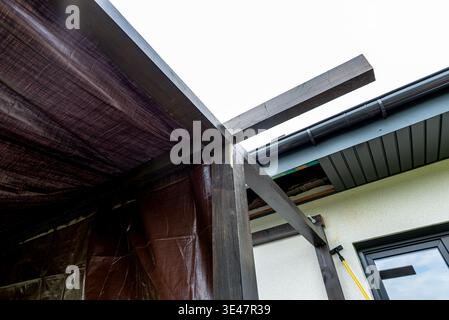 Worker is assembling wooden frame beams trusses during work day Stock ...