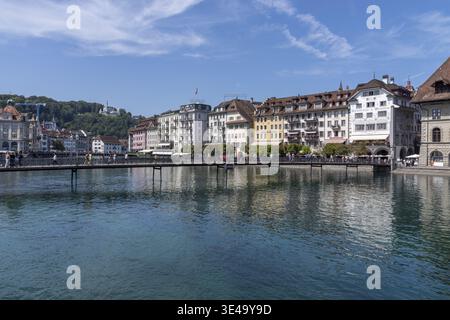 Lucerne old town buildings lining the Reuss River at dusk, Jesuit ...