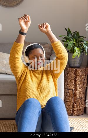 A white sweater hanging over the back of a white chair in the interior ...