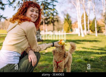 Woman dog puppy grass park fence field pet outdoor trainer gathered ...