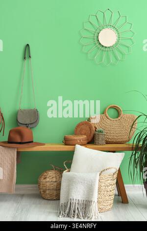Baskets on bench and pouf near wooden wall in room Stock Photo - Alamy