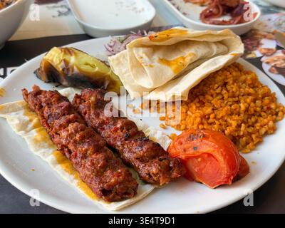 A hearty portion of pilaf with meat and vegetables served in a textured ...