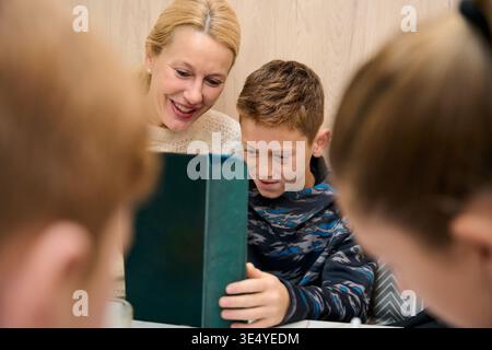 Smiling children reading and learning at home Stock Photo - Alamy
