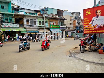 Motorcycles, and pedestrians move through a busy street in Bunia, Congo ...
