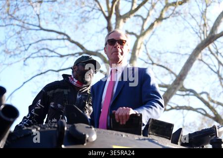 Derek Chisora (left) arrives with Reform UK leader Nigel Farage on top ...