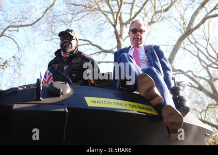 Derek Chisora (left) arrives with Reform UK leader Nigel Farage on top ...