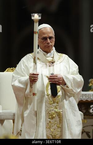 Pope Leo XIV holds the gospel during a Mass for the Solemnity of ...