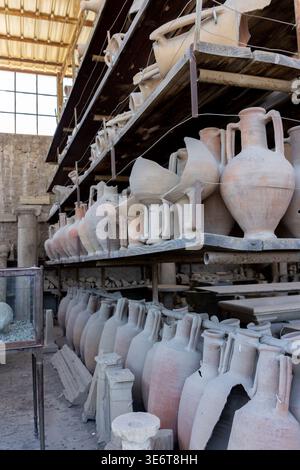 A collection of clay pots in various shapes, sizes, and colors are ...