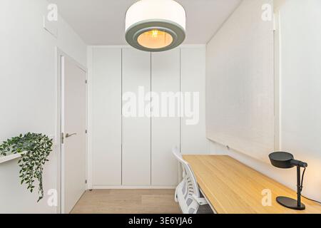 A newly built, modern room showcases modular built-in wardrobes with ...