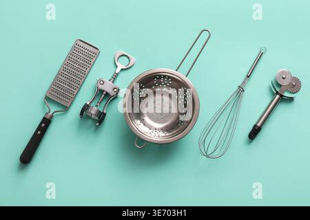 Colander with different kitchen utensils on wooden background Stock ...