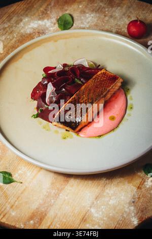 Crispy Skin Fish Served on a Bed of Vibrant Greens With a Side of ...