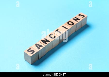 Cubes with word SANCTIONS on blue background Stock Photo - Alamy