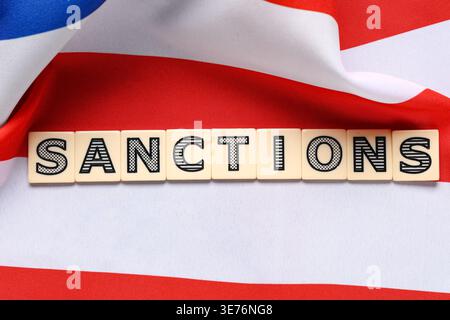 Word SANCTIONS on USA flag Stock Photo - Alamy