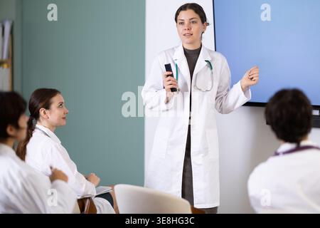 young Asian female doctor presenting anatomical model during video ...