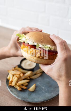 Woman holding crispy chicken burger ready to eat Stock Photo - Alamy