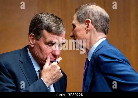 Sen. Mark Warner, D-Va., and Sen. Ron Wyden, D-Ore., speak during a ...