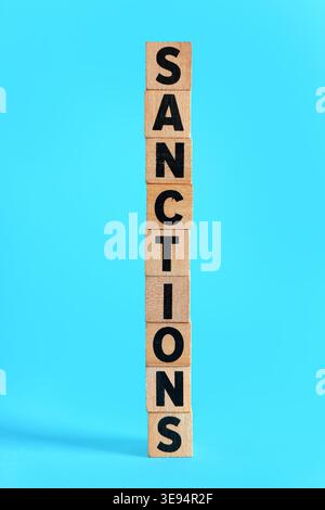 Cubes with word SANCTIONS on blue background Stock Photo - Alamy
