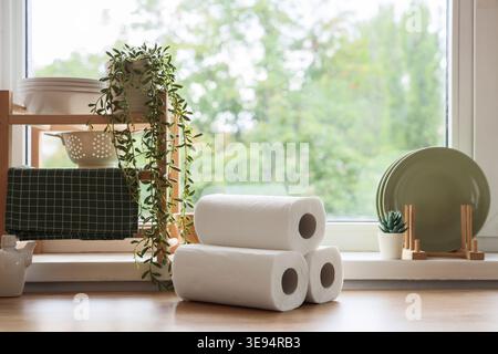 Rolls of paper towels with plant on table in kitchen Stock Photo - Alamy