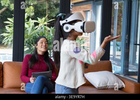Asian woman playing VR gaming virtual reality headset with controller ...