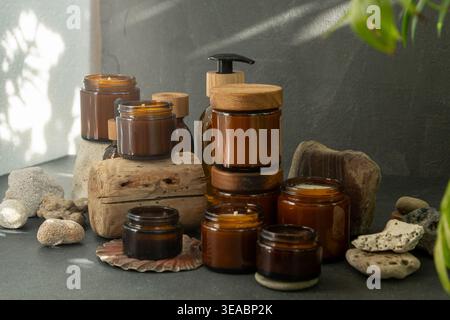 Amber Candles Glass Jars and Bottles with stones shell Stock Photo - Alamy