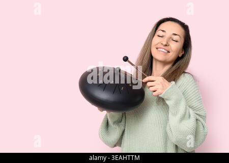 Beautiful mature woman with sticks playing glucophone and sitting on ...