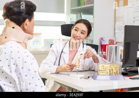 Asian female doctor teaching human anatomy using organ model laptop ...