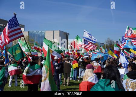 Pro-government demonstrators wave Iranian flags in a gathering at a ...