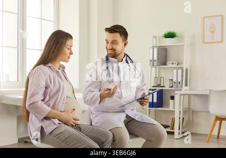 Pregnant woman smiling during a medical ultrasound examination showing ...
