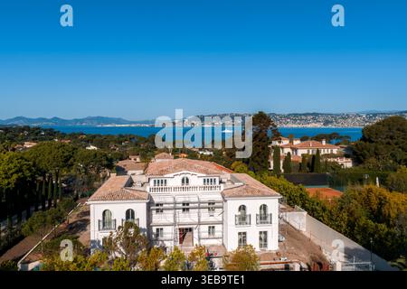 Aerial view of luxury terracotta villa rooftops above Mediterranean Sea ...