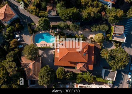 Aerial view of luxury terracotta villa rooftops above Mediterranean Sea ...
