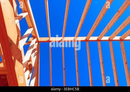 Construction workers install wooden beams panels on new porch in forest ...