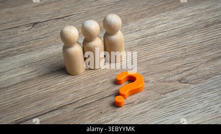 Wooden figures standing on puzzle pieces arranged in a circle ...