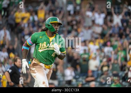Athletics' Lawrence Butler, right, runs after hitting a single during ...