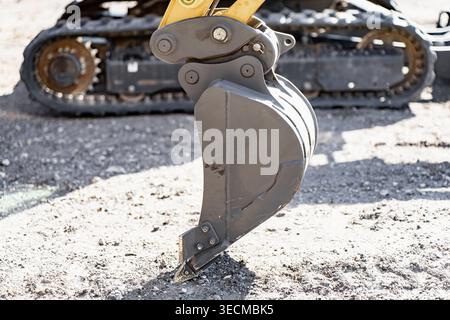 Industrial excavator digging in a dry, cracked earth landscape with ...