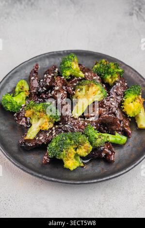 Chinese Beef and Broccoli Skillet served on a dark textured background ...