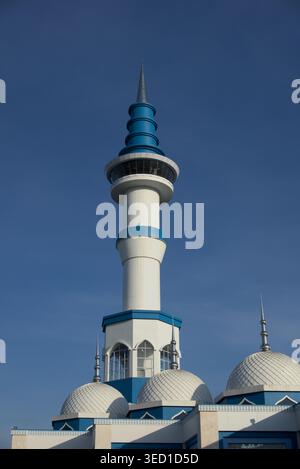 Low-angle view of a modern mosque dome featuring a white patterned roof ...